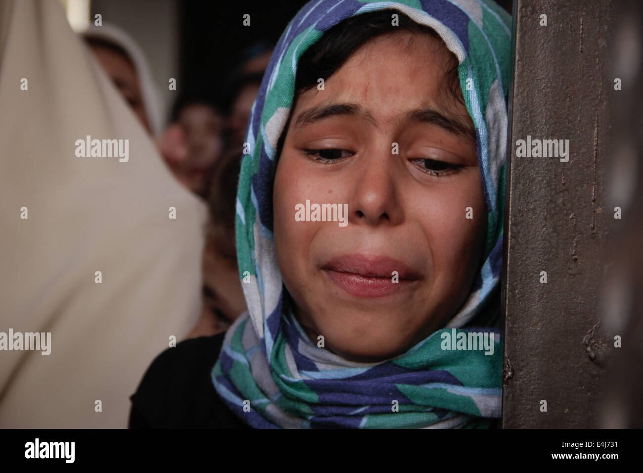 Gaza. 12th July, 2014. Palestinian girl crying during the funeral of ...