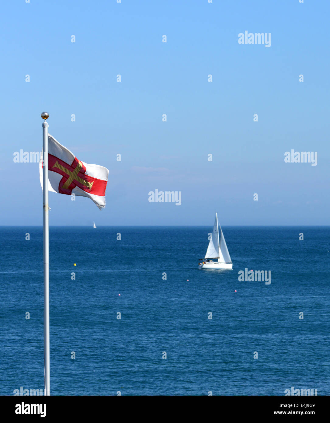Flag of Guernsey overlooking the sea Stock Photo - Alamy