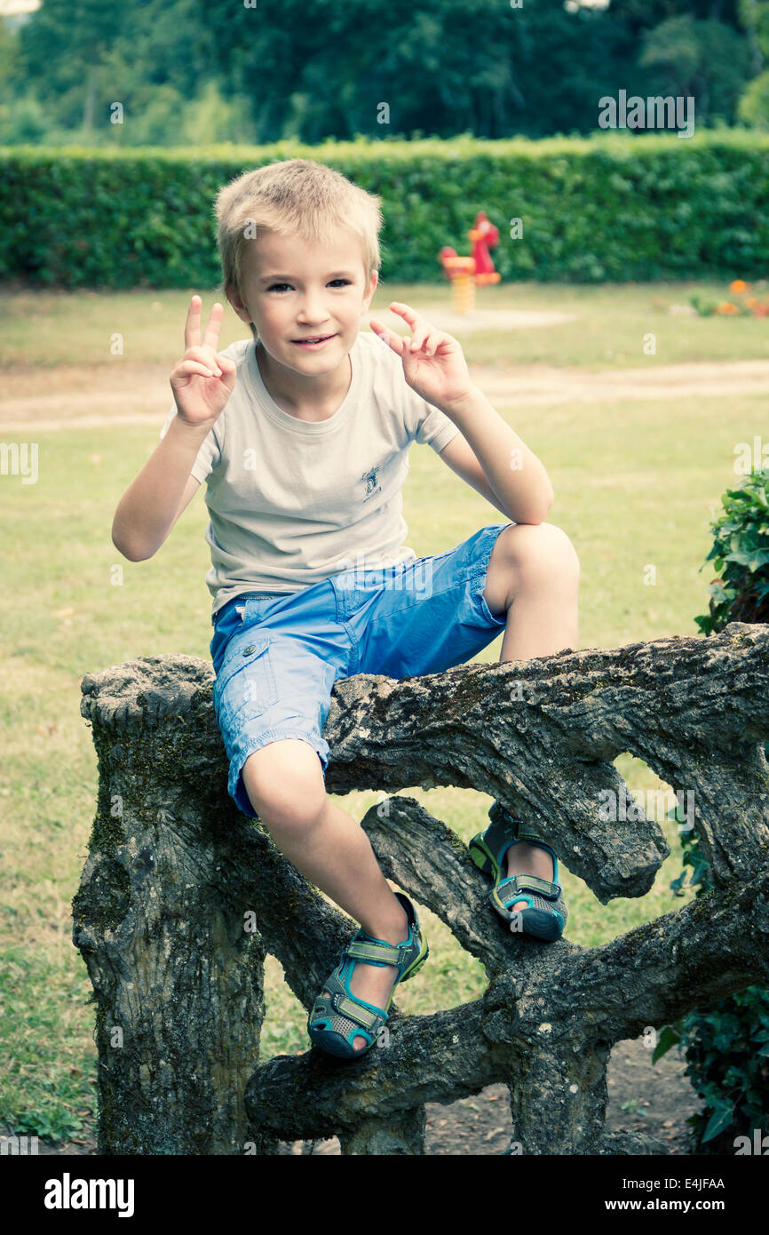 Young boy outdoors at a park Stock Photo - Alamy