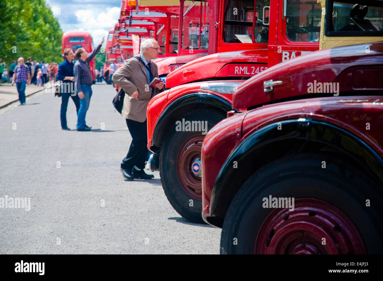 An enthusiast notes down the registration plates of old London red ...