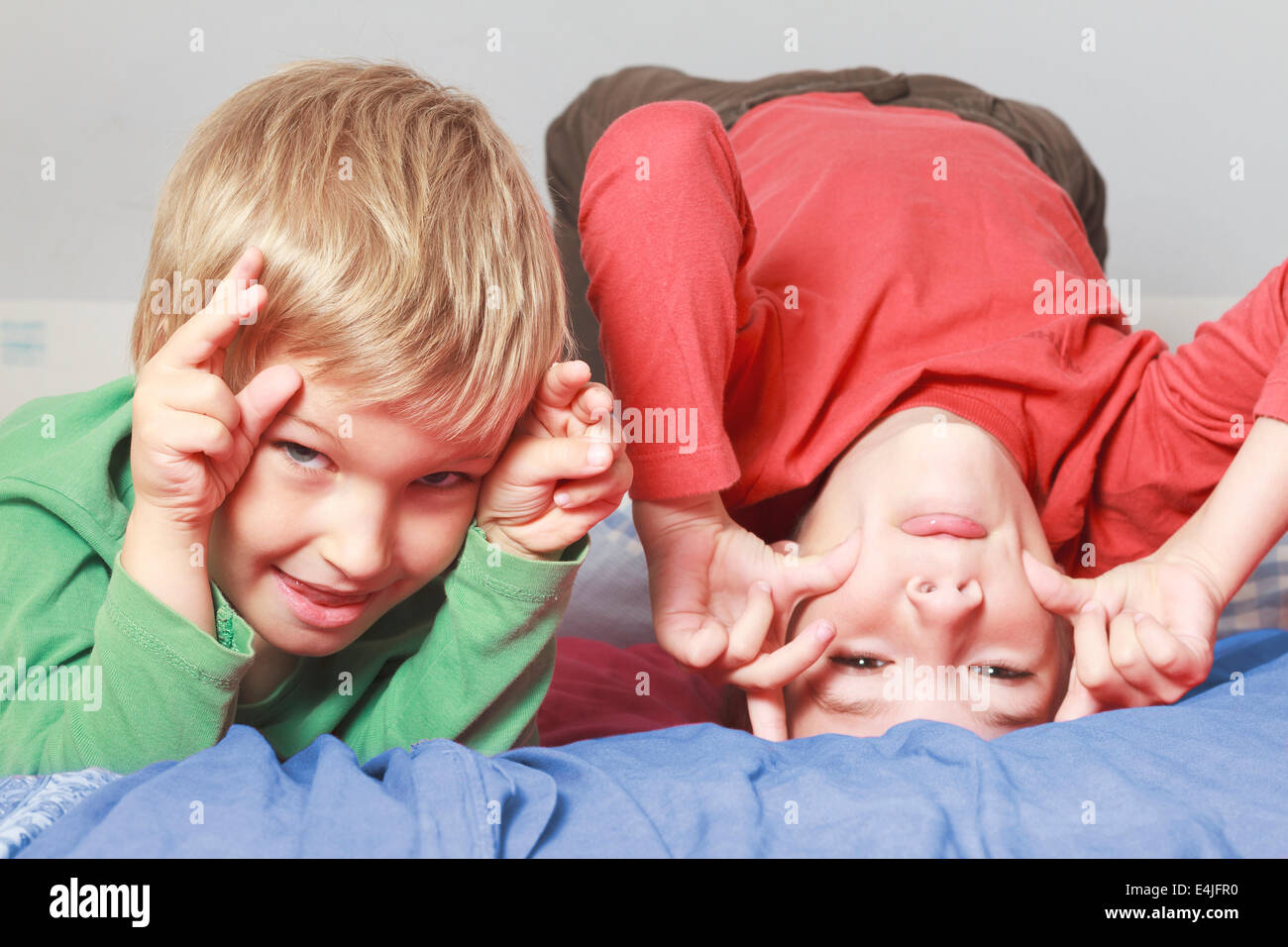 Two boys pulling faces (5-7 years Stock Photo - Alamy