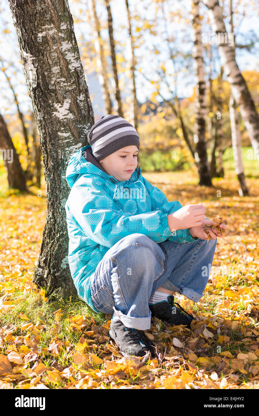 Sad boy in the autumn park Stock Photo - Alamy