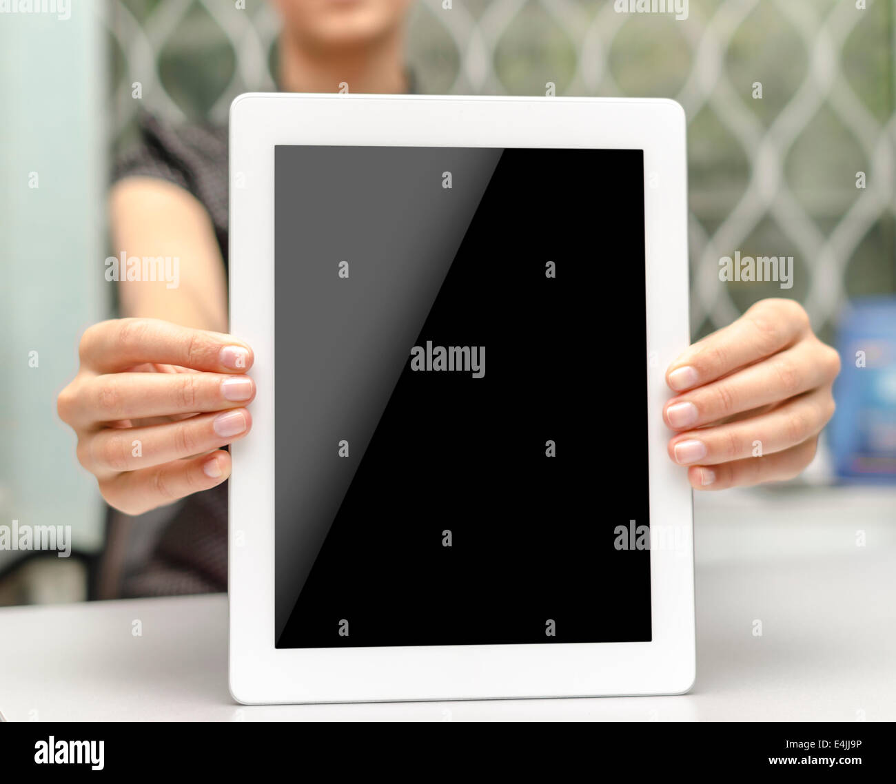 Woman showing tablet pc in the office Stock Photo - Alamy