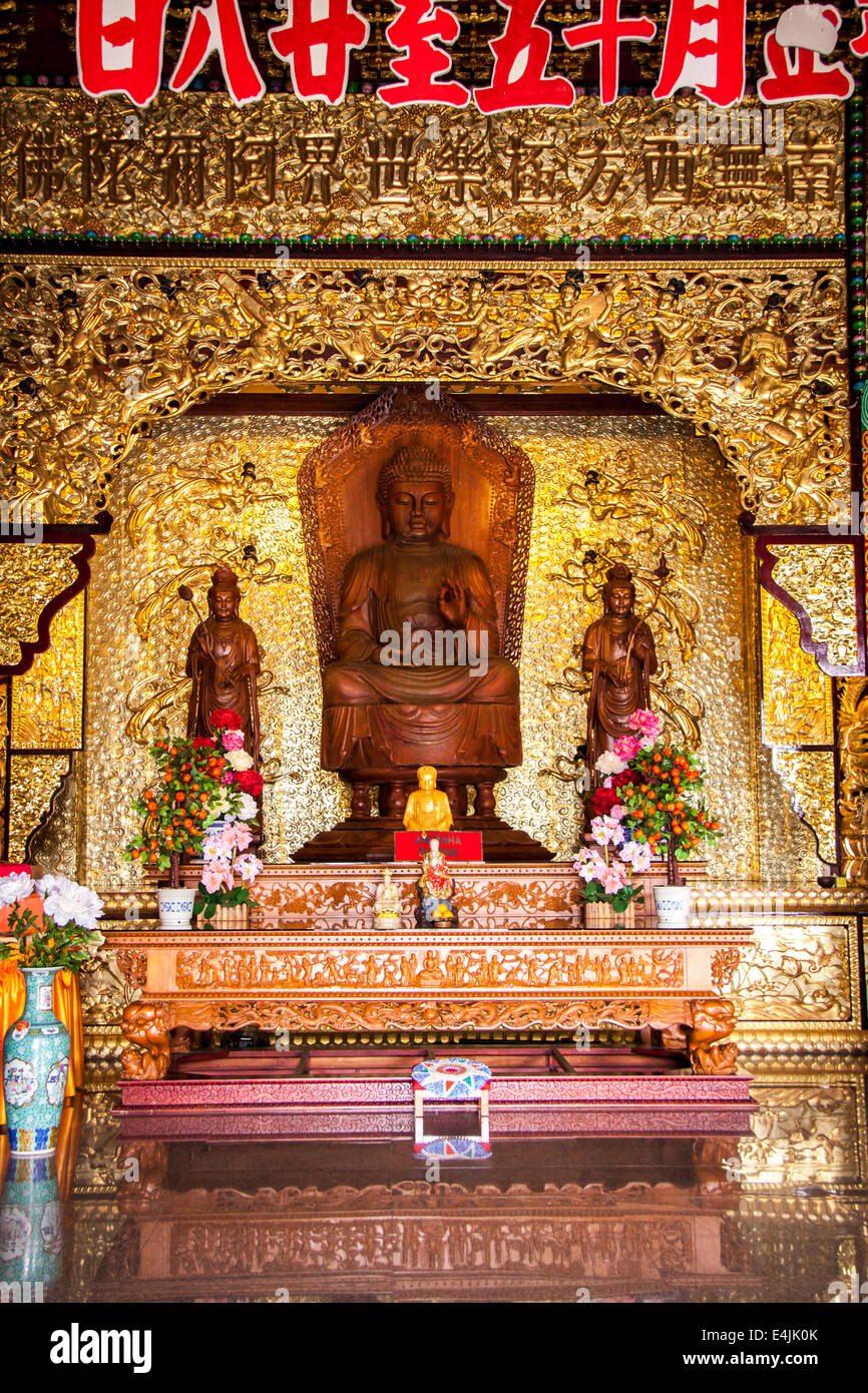 Interior of an ornate Asian temple with statues f deities in recesses ...