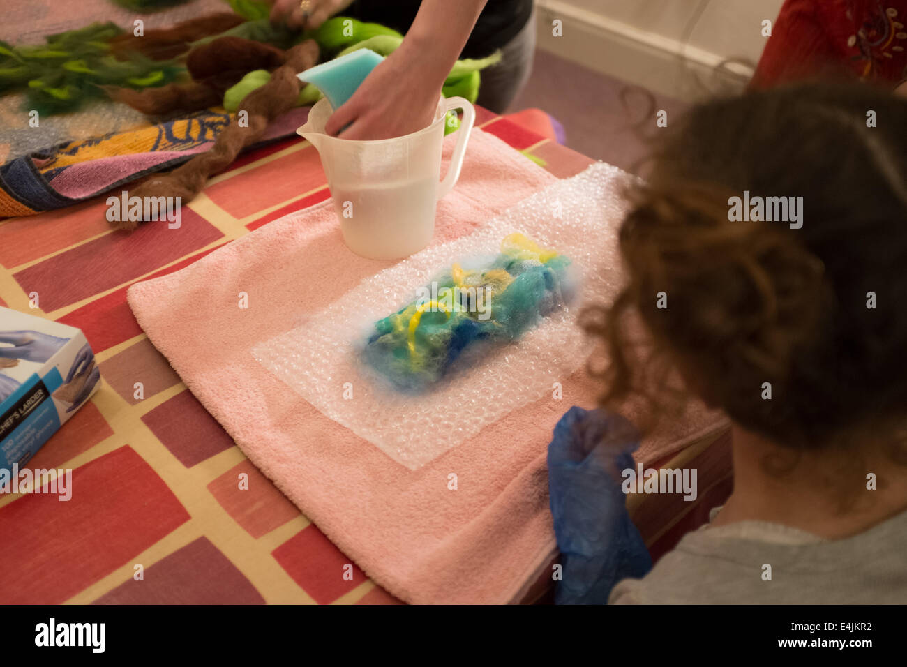 making felt using bubble wrap - getting ready to wet the fibres Stock ...