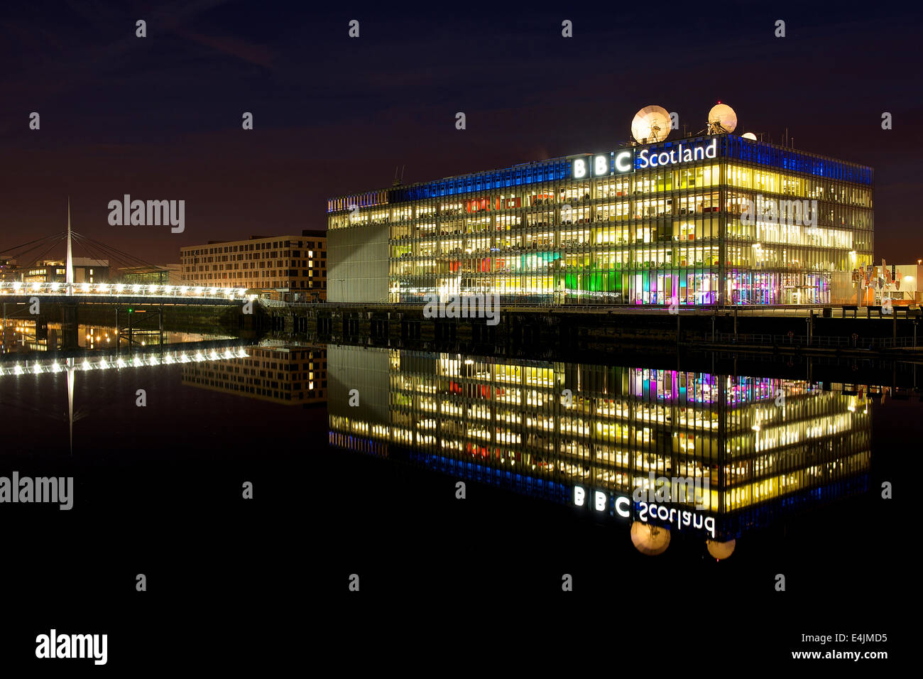 A reflection at night of the BBC scotland studio's and Bells bridge in ...