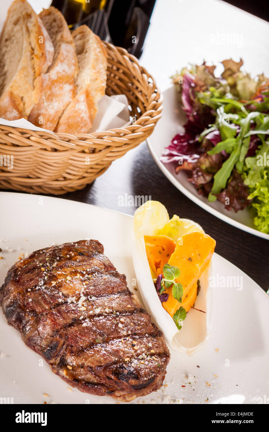 Delicious trimmed lean portion of thick grilled beef steak with ...