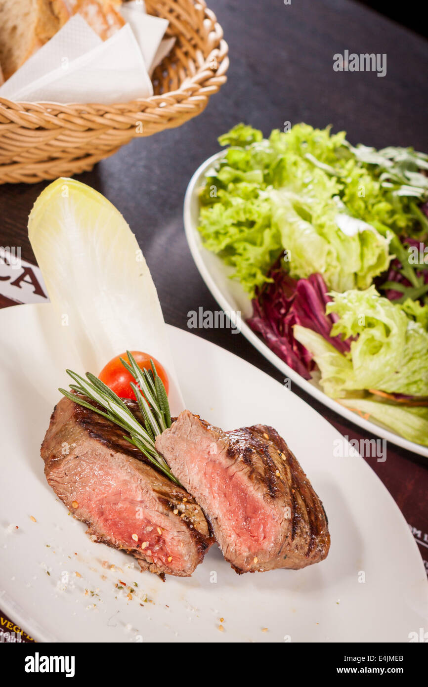 Succulent medium rare beef steak sliced through to display the tender ...