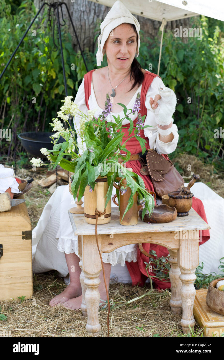 Lady in Medieval clothing on a market stall Stock Photo - Alamy