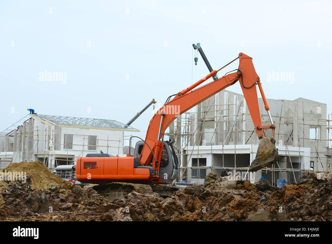 Excavator working in new housing building project Stock Photo - Alamy