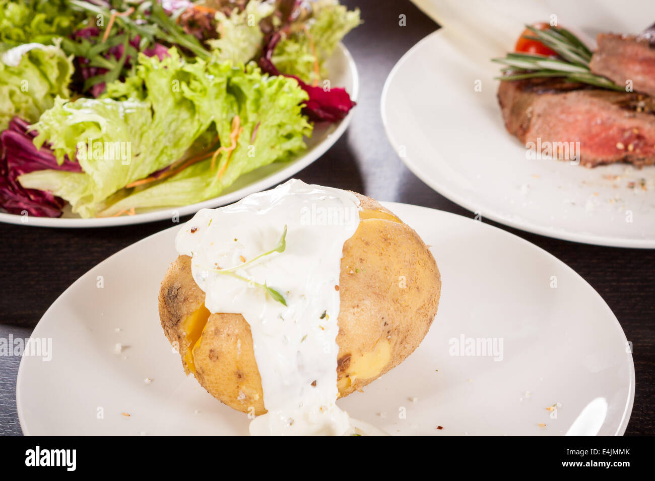 Overhead view of a healthy oven baked jacket potato with sour cream ...