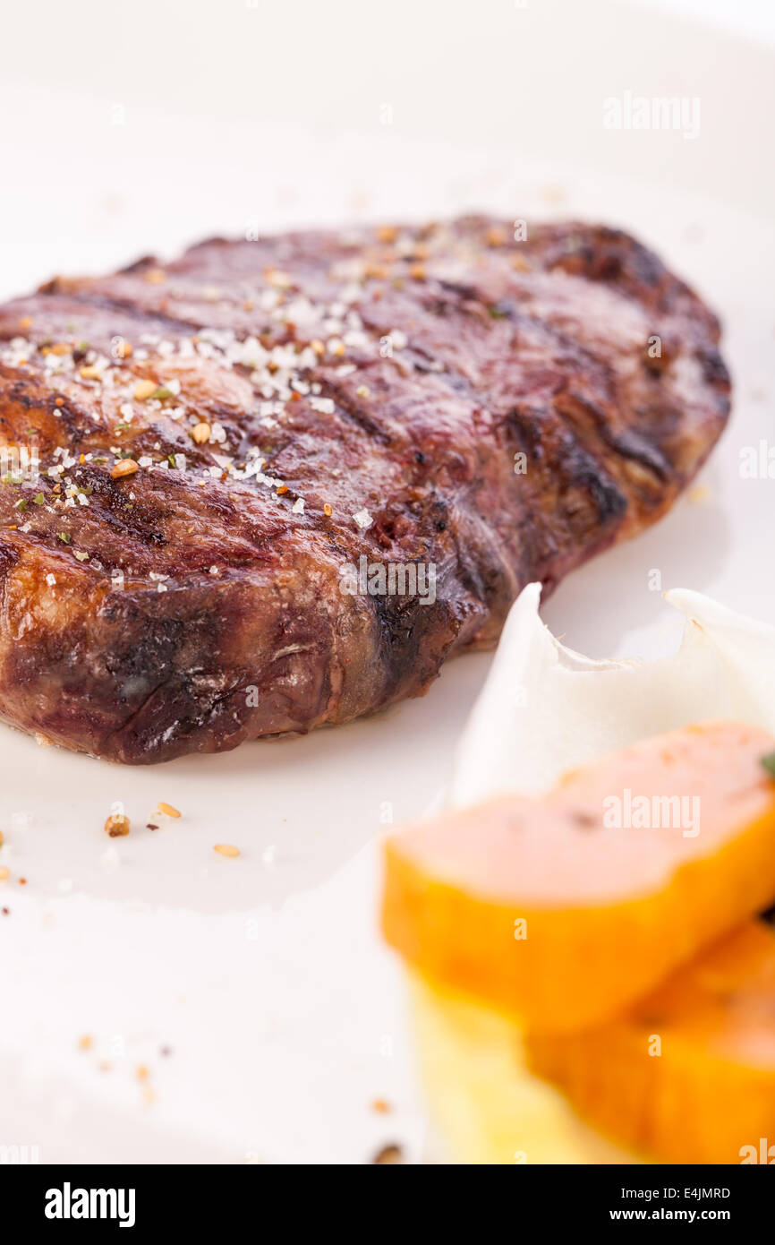 Delicious trimmed lean portion of thick grilled beef steak with ...