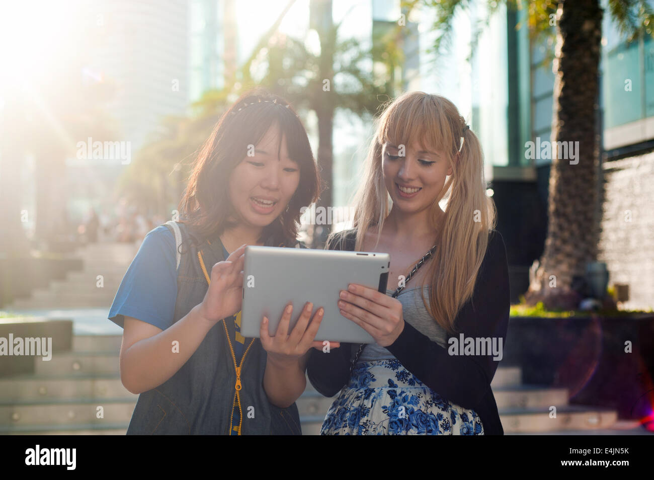 Using tablet asian woman hi-res stock photography and images - Alamy