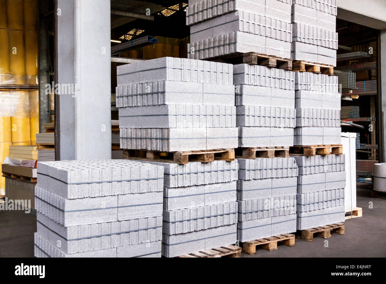 Red clay building bricks stacked on pallets still wrapped in their ...