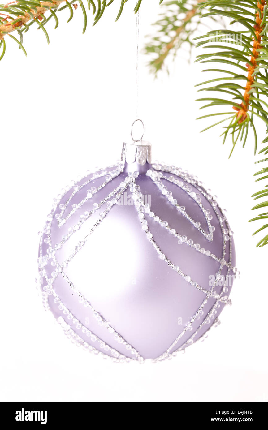 Traditional and shiny Christmas ball hanging from a branch of a green ...