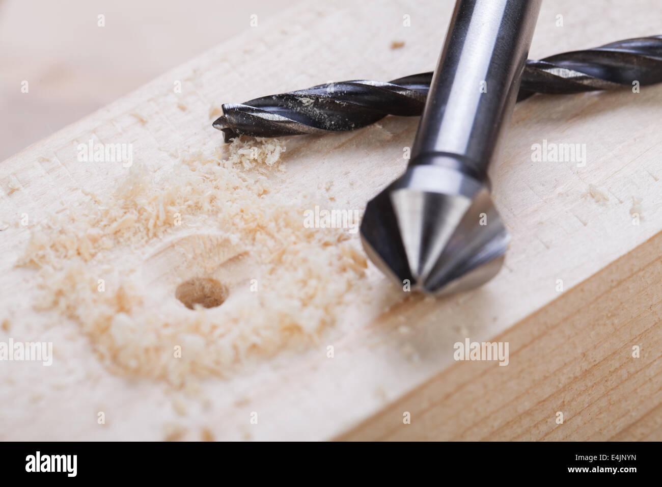 Battery operated hand drill standing amongst planks of new wood with a ...