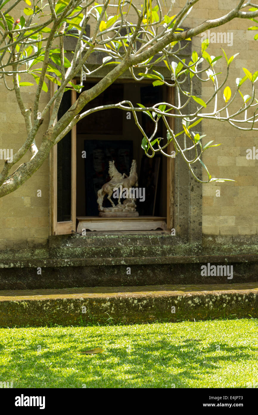 Ornamental fountain in a shallow pond in a landscaped garden outside a ...