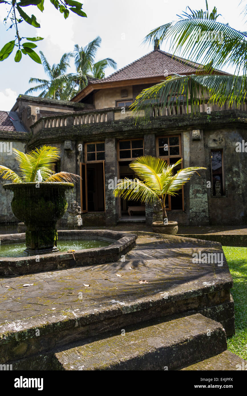 Ornamental fountain in a shallow pond in a landscaped garden outside a ...
