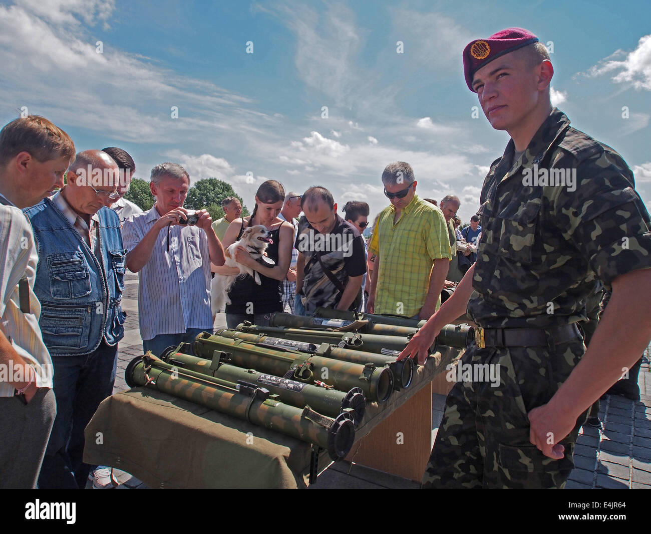 Kyiv, Ukraine. 13th July, 2014. Visitors examine shoulder held Russian ...