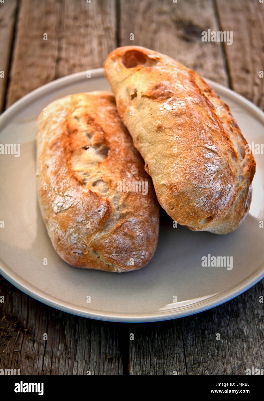 Fresh bread rolls on wooden table Stock Photo - Alamy