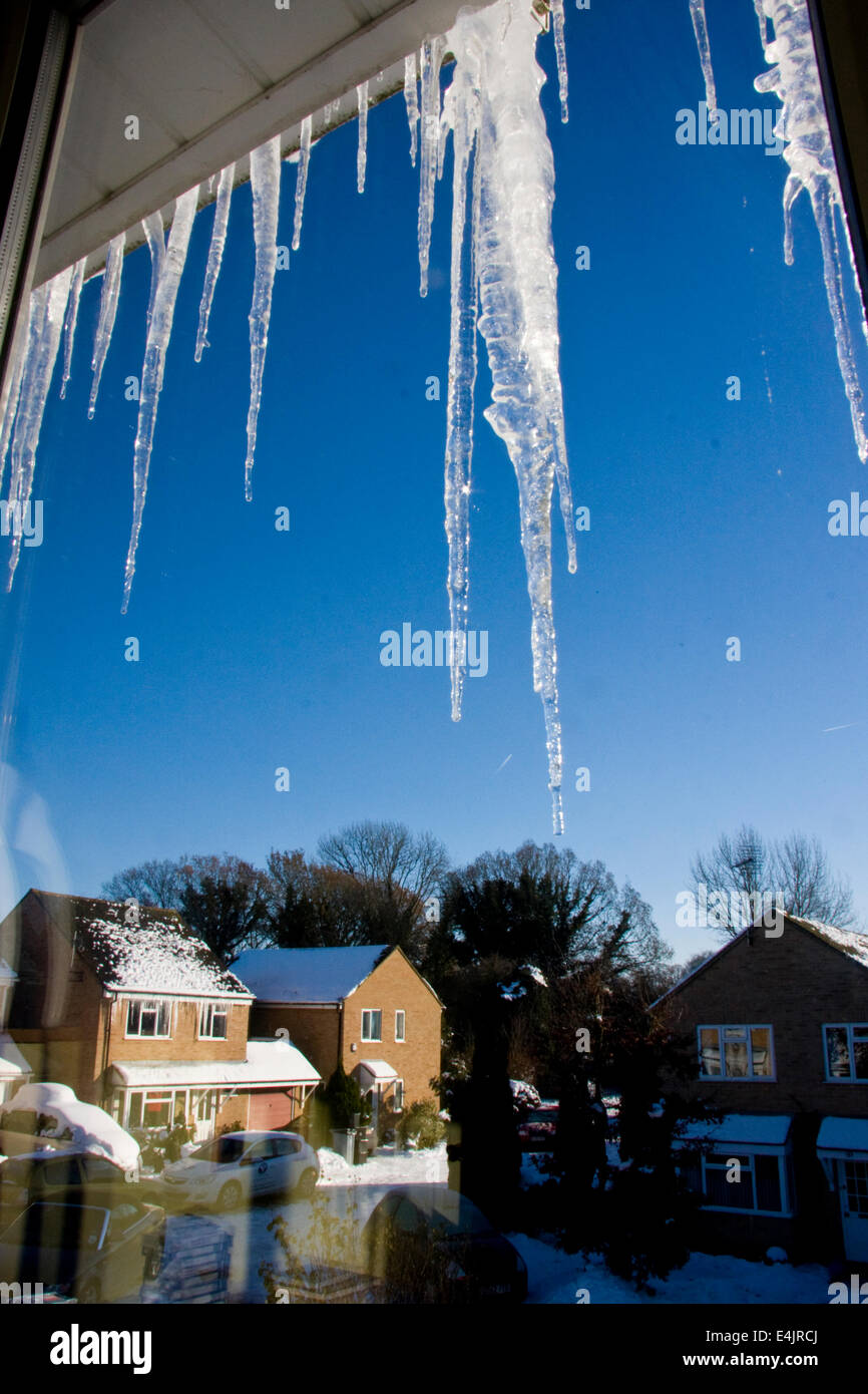 Icicles seen through a window Stock Photo - Alamy