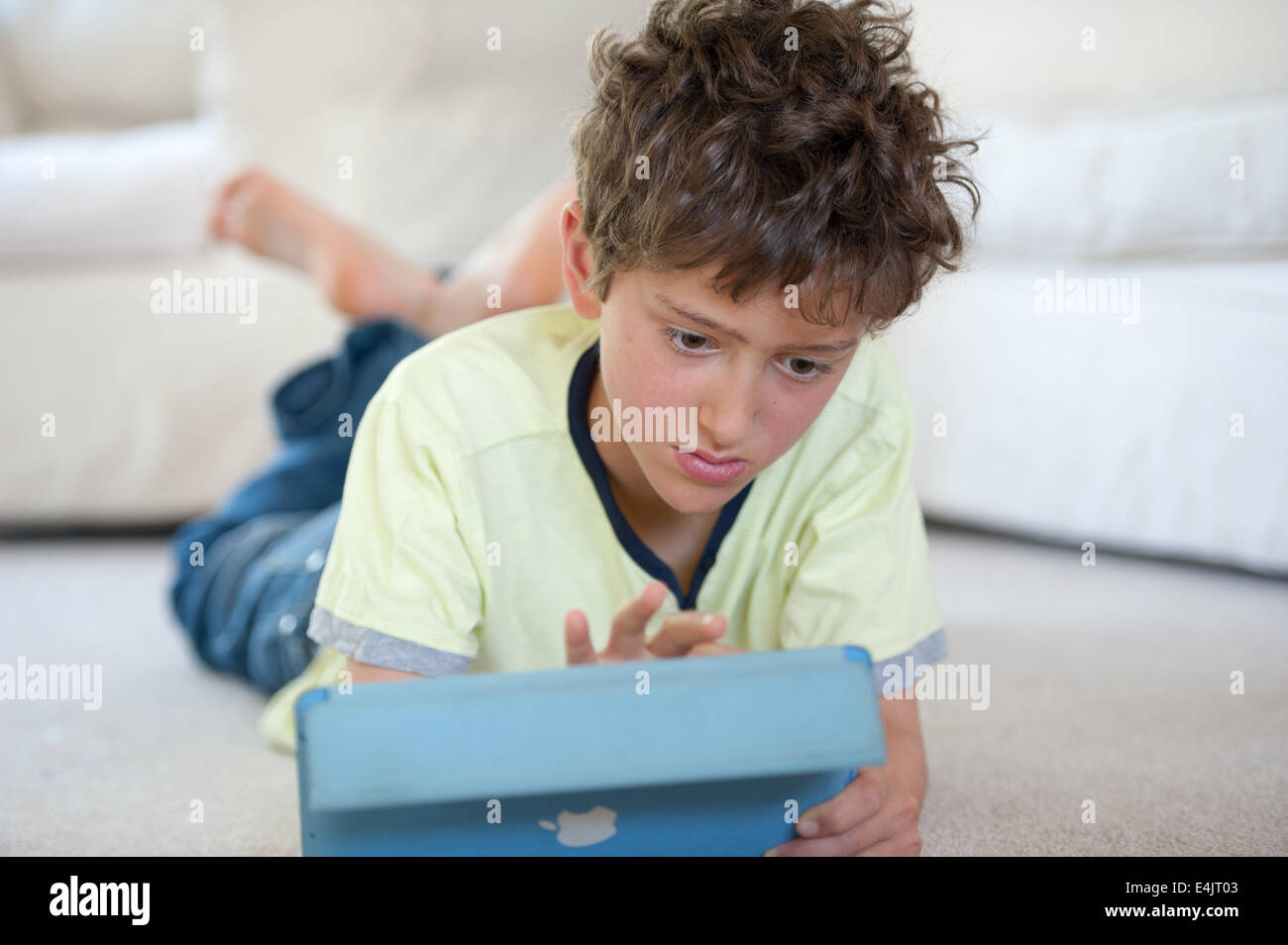 Boy using an Apple iPad tablet Stock Photo - Alamy