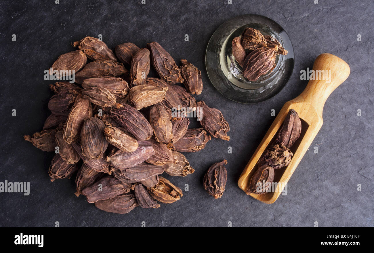 Black cardamom pods on dark stone background Stock Photo - Alamy