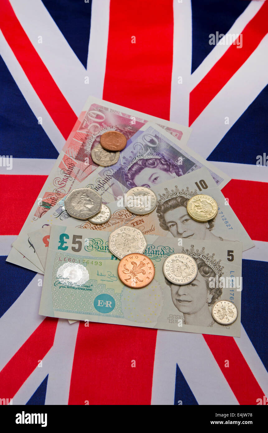 British pound notes and coins on a union jack flag Stock Photo - Alamy