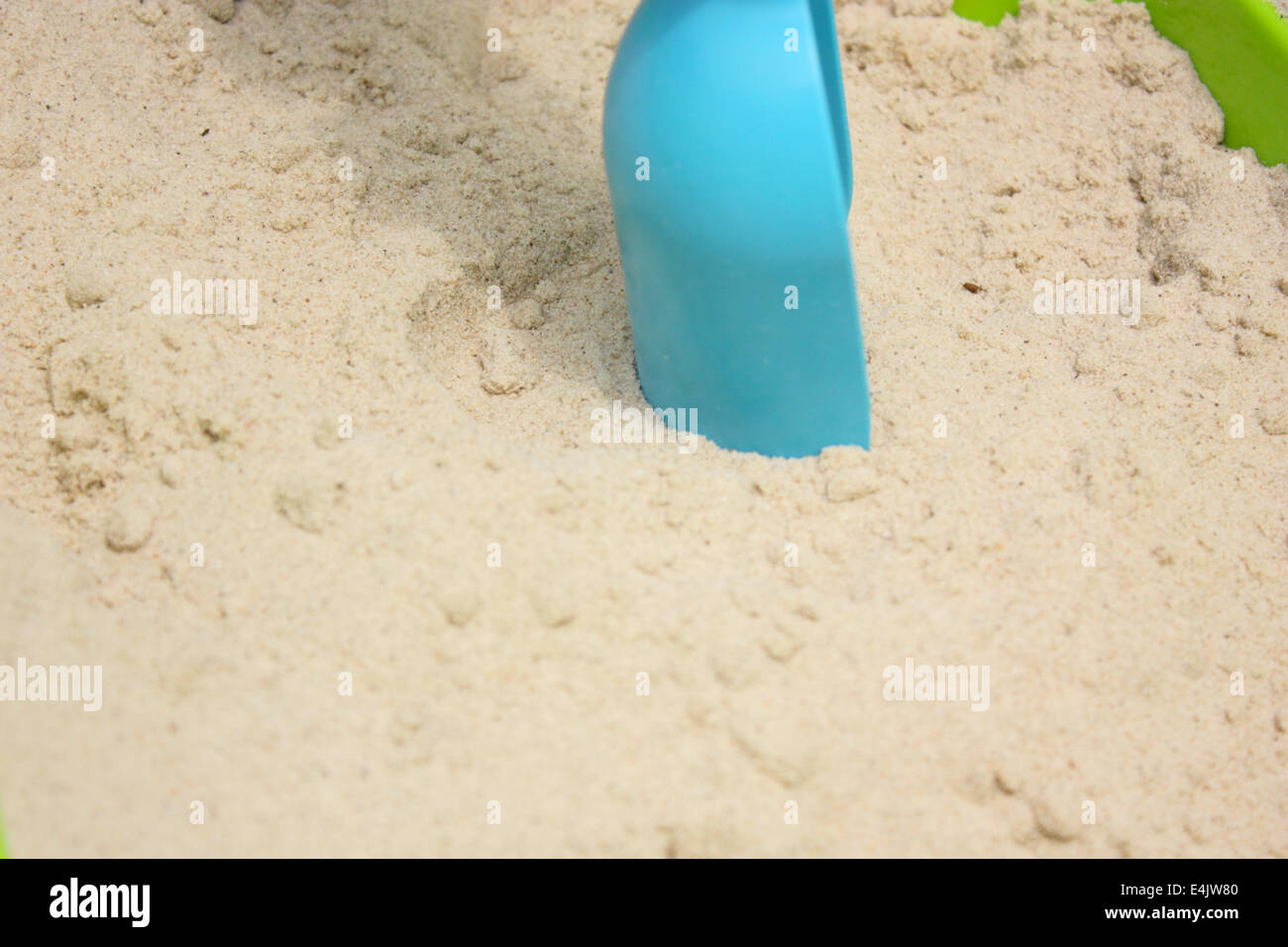 An image showing the concept of summer fun in the sand with a spade in ...
