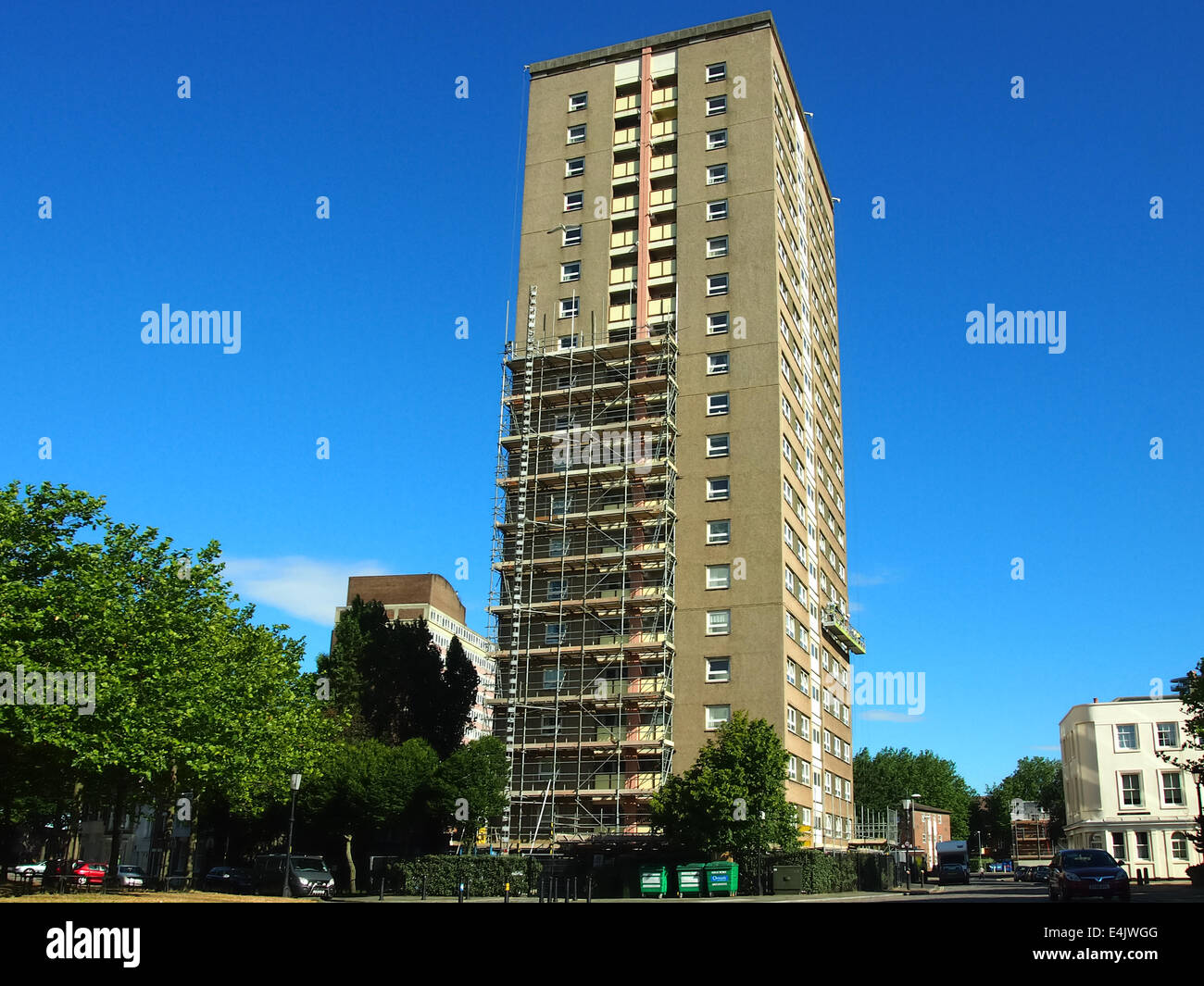 High rise tower block undergoing repair with scaffolding around the ...