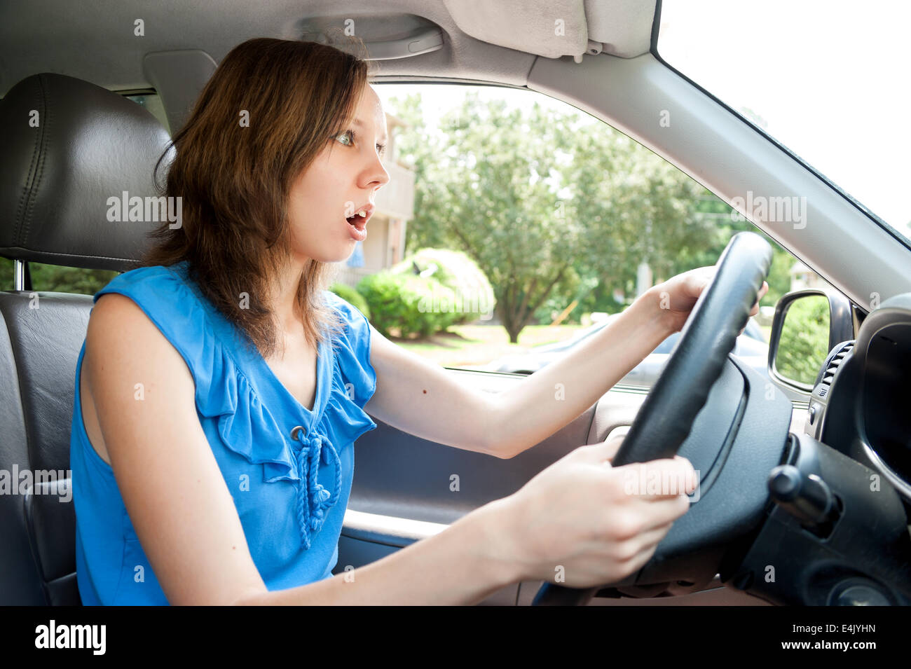 Young woman panic in a car Stock Photo - Alamy