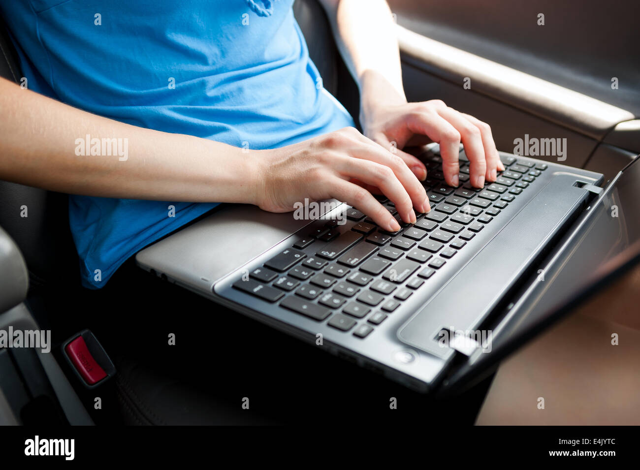Girl with laptop in a car Stock Photo - Alamy