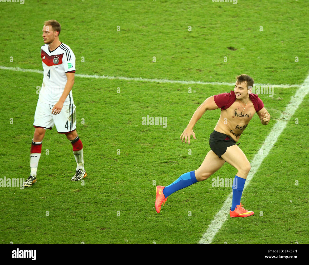 Rio De Janeiro, Brazil. 13th July, 2014. A fan runs into the field ...