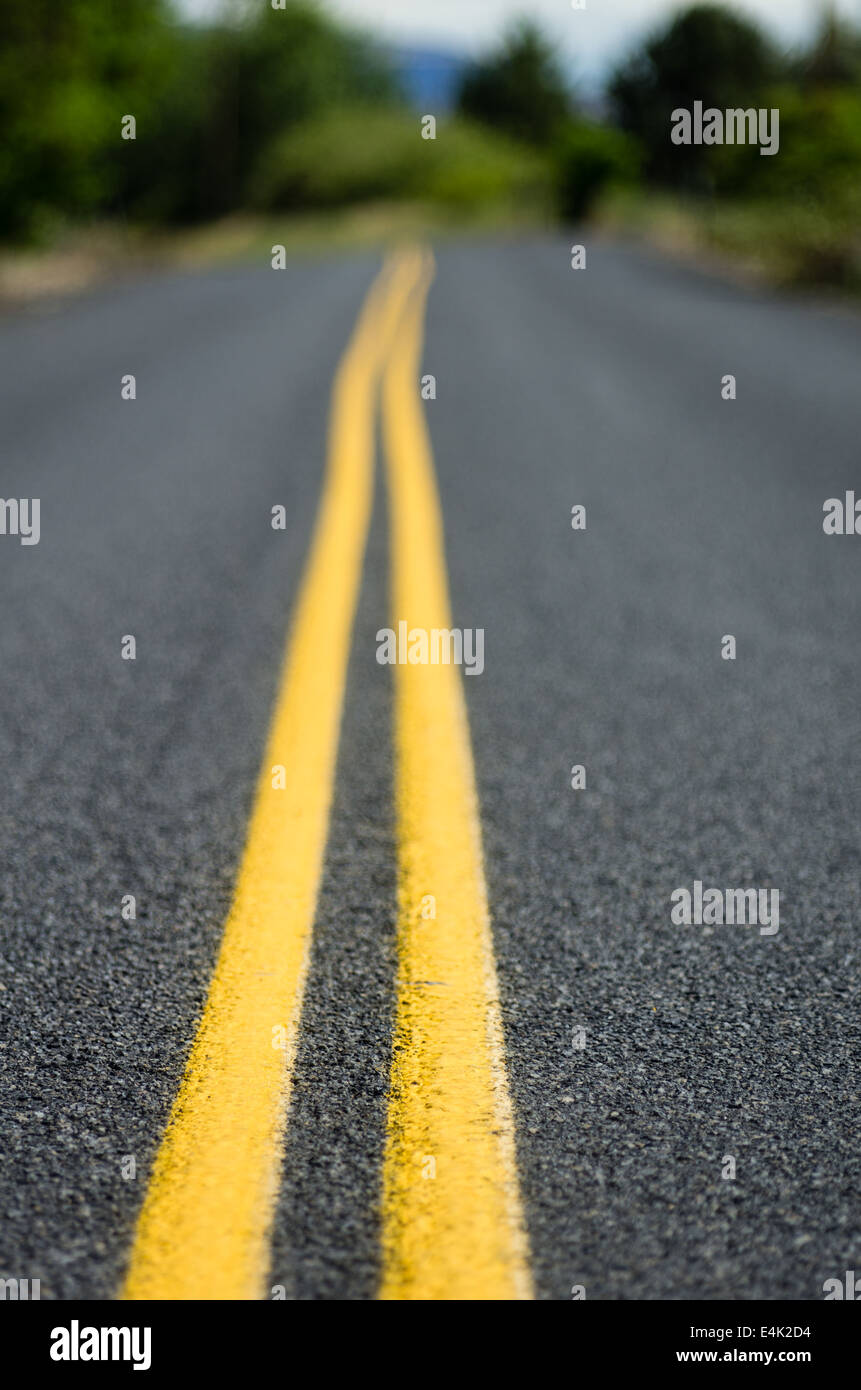 Yellow traffic control lines on a rural roadway Stock Photo - Alamy