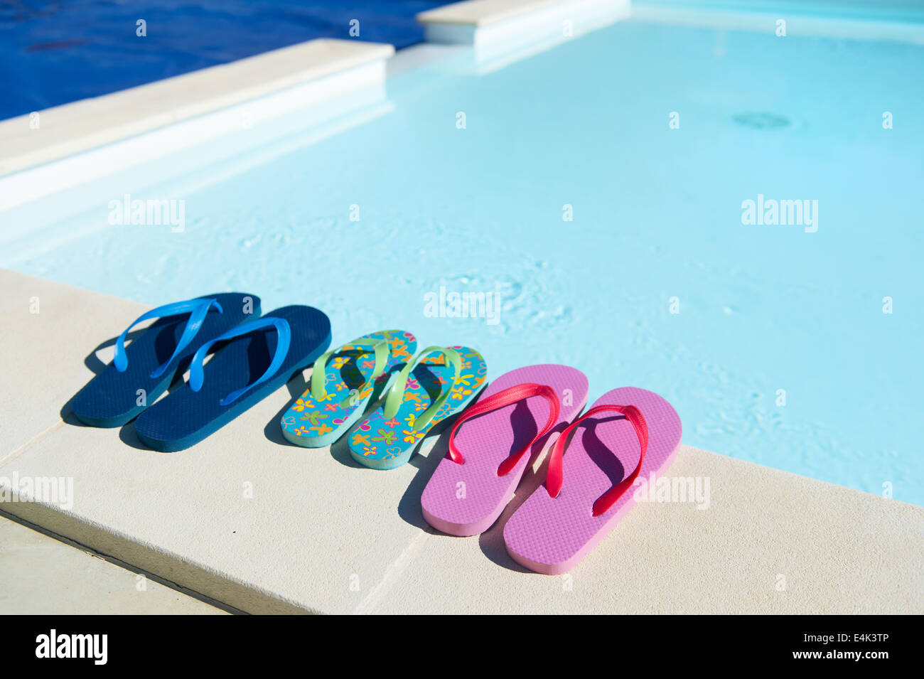 Flip flops from the whole family at the swimming pool Stock Photo - Alamy
