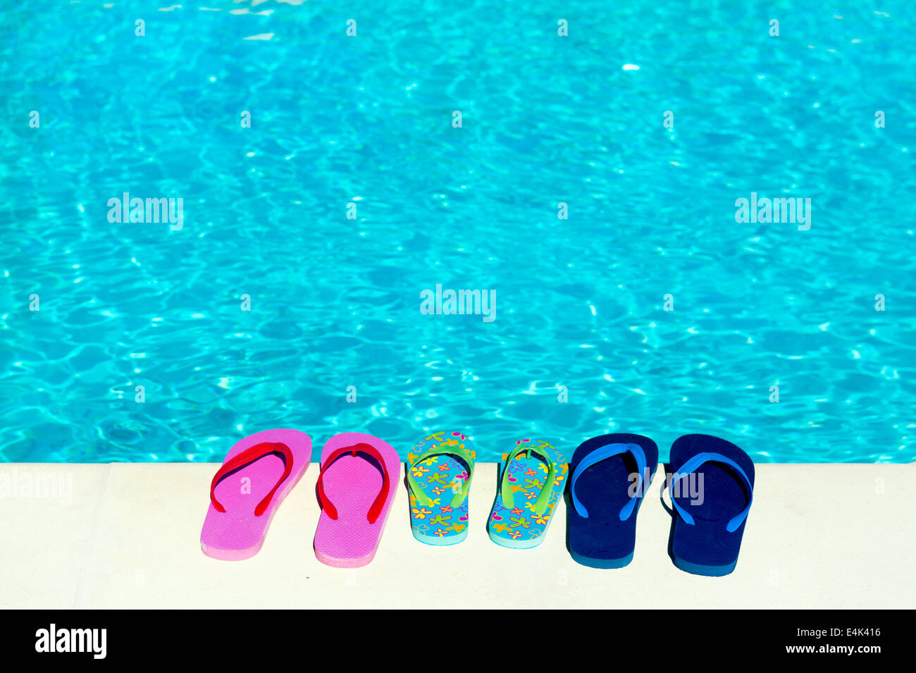 flip flops at swimming pool from the family Stock Photo - Alamy