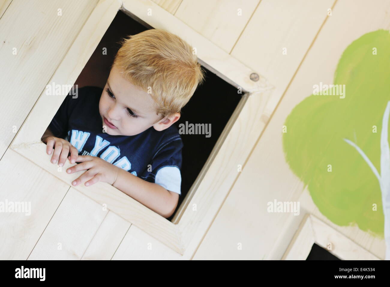 happy child in a window Stock Photo - Alamy