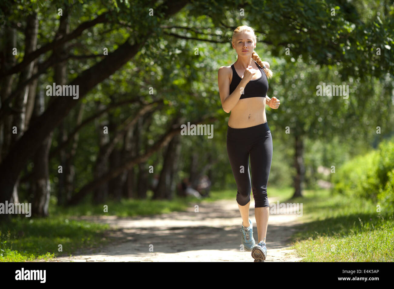 Running woman in park Stock Photo - Alamy