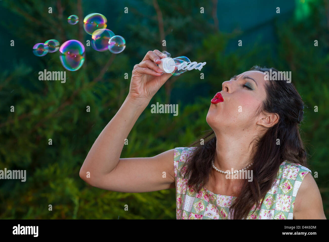 a beautiful woman blowing bubbles. spring season, rural scene Stock Photo - Alamy