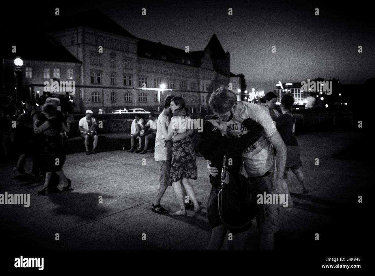 Kissing couple during tango dancing late at night outdoor on the street ...