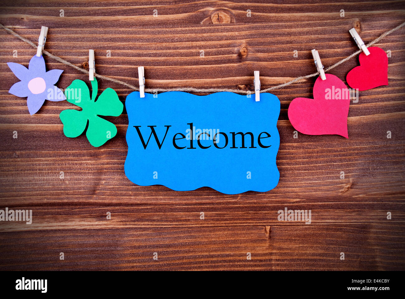 Blue Tag with Welcome on it Hanging on a Line with Different Symbols ...