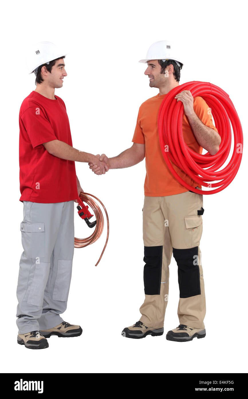 Plumbers shaking hands Stock Photo - Alamy