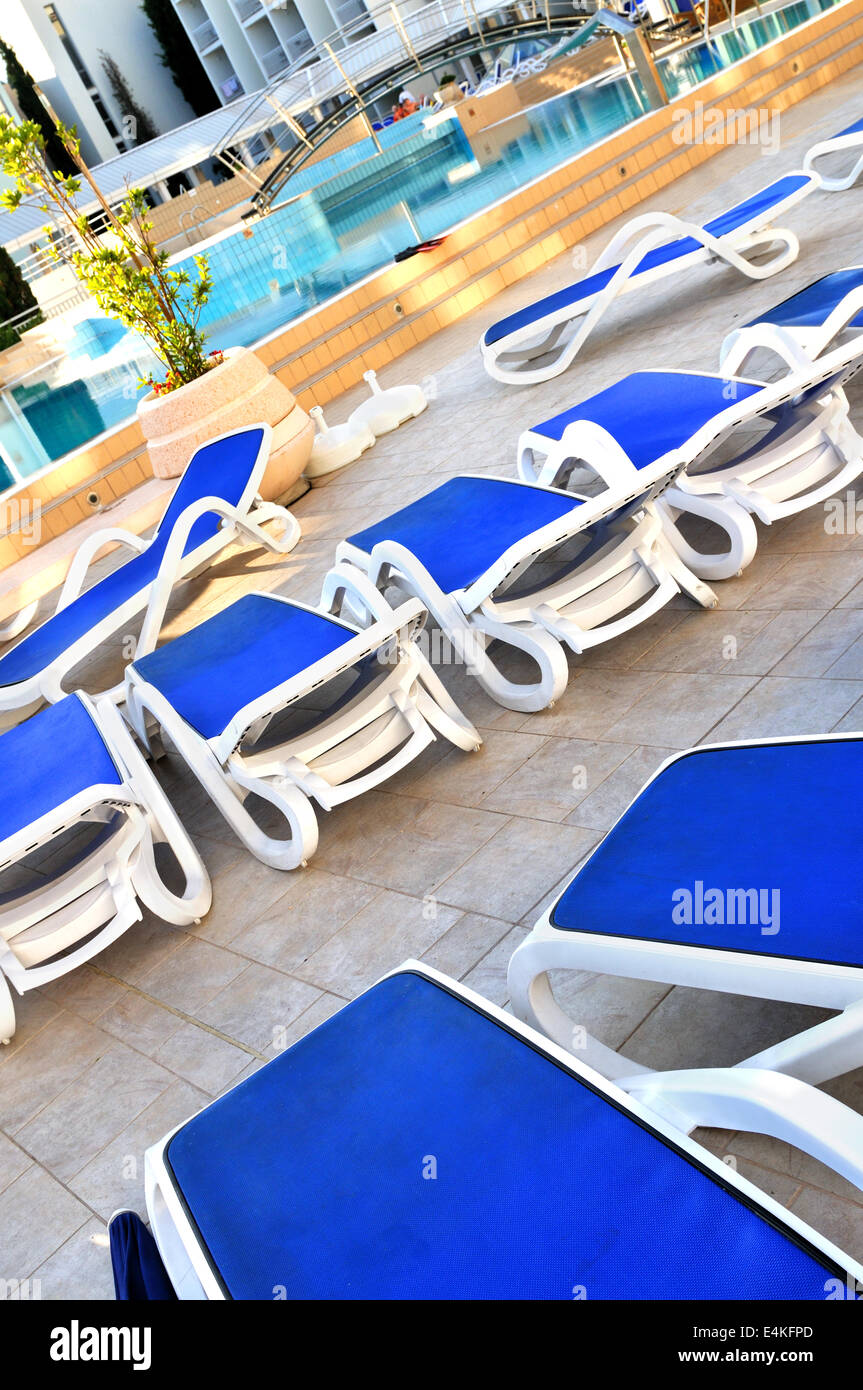 Empty chairs by the pool of hotel Stock Photo - Alamy