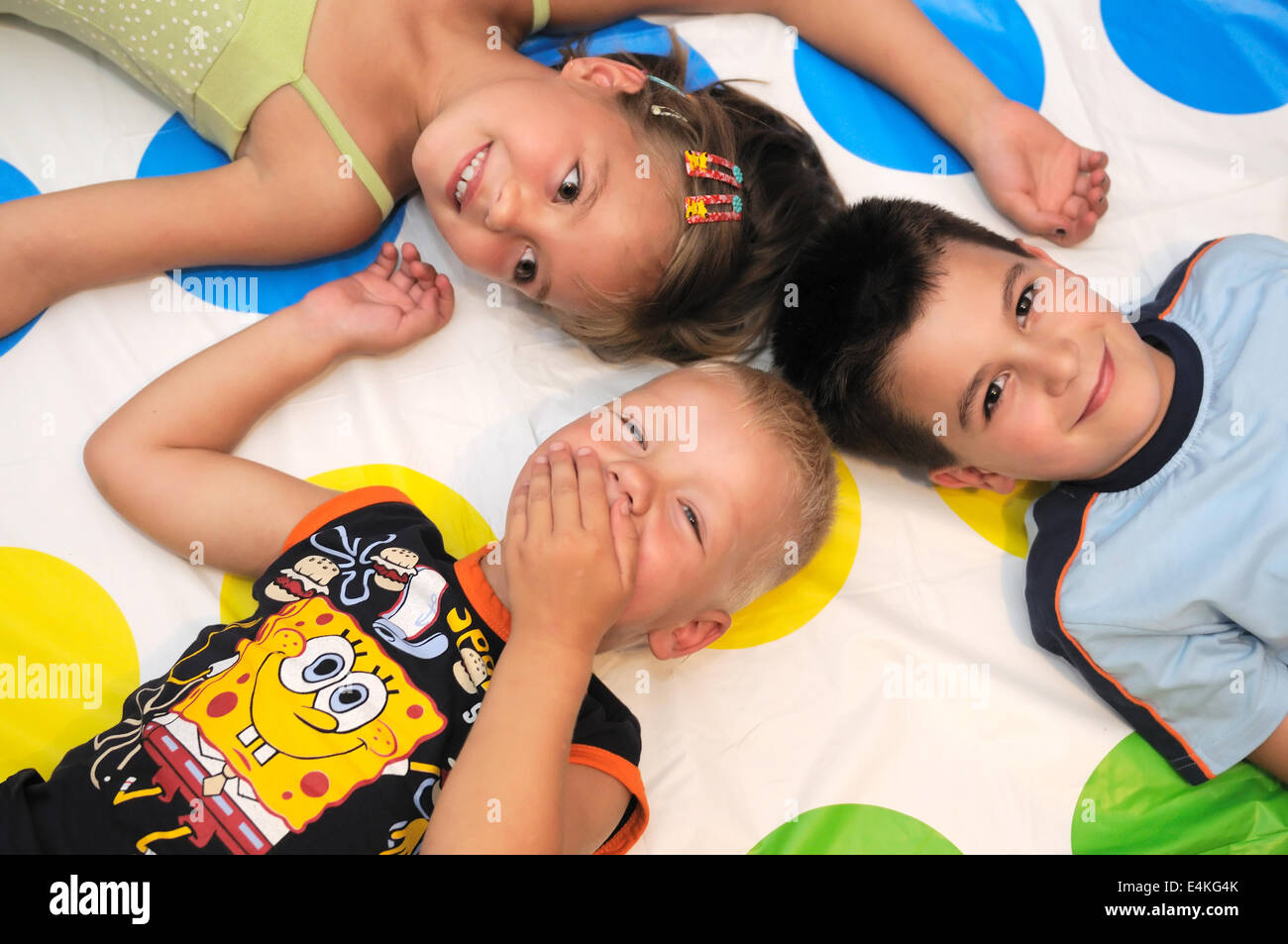 Happy three kids playing together Stock Photo - Alamy