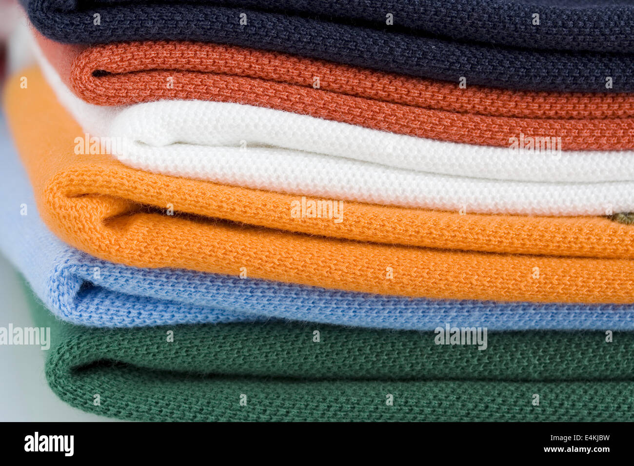 Colored polo shirt pile Stock Photo - Alamy