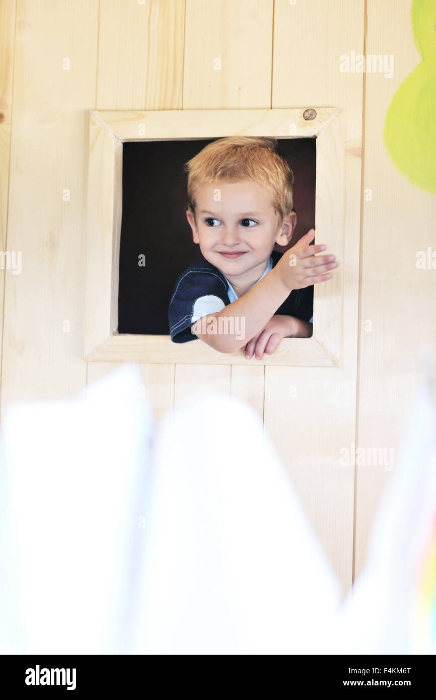 happy child in a window Stock Photo - Alamy