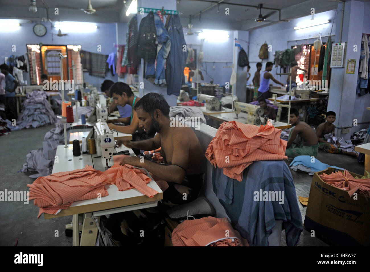 Bangladeshi garment worker sewing clothes in a factory for the domestic ...