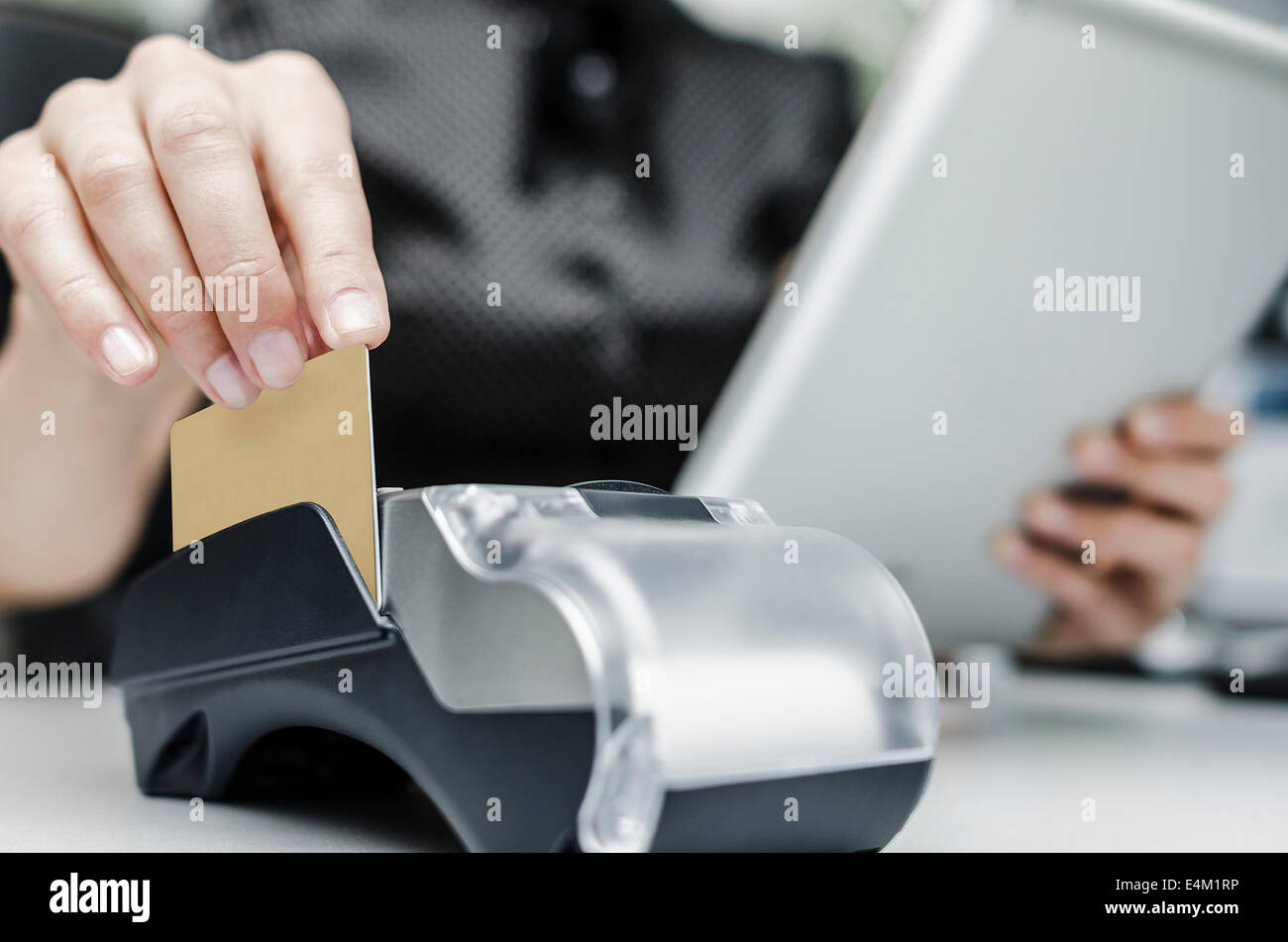 Female hand holding bank terminal and tablet pc Stock Photo - Alamy