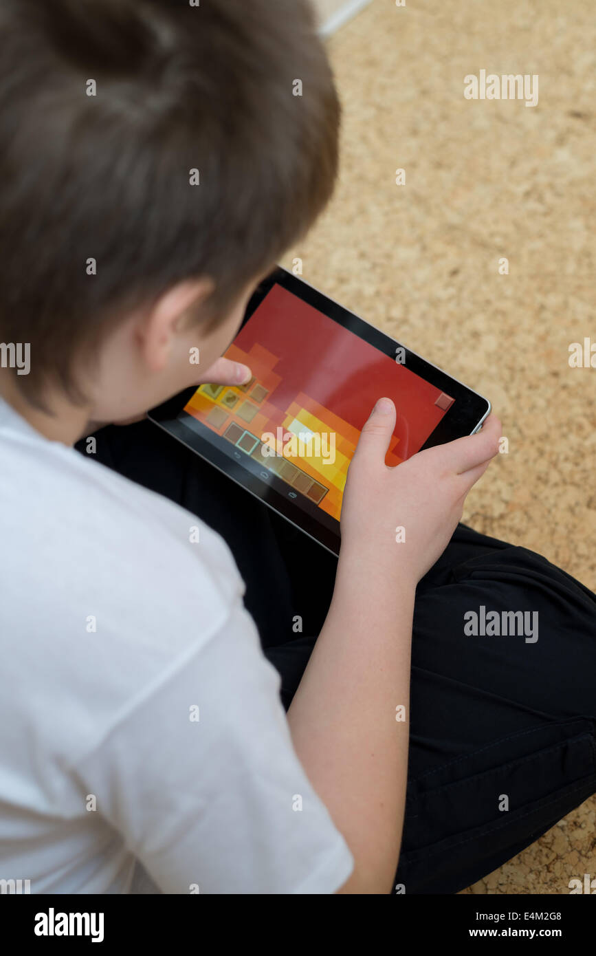 Boy playing on a Tablet PC Stock Photo - Alamy