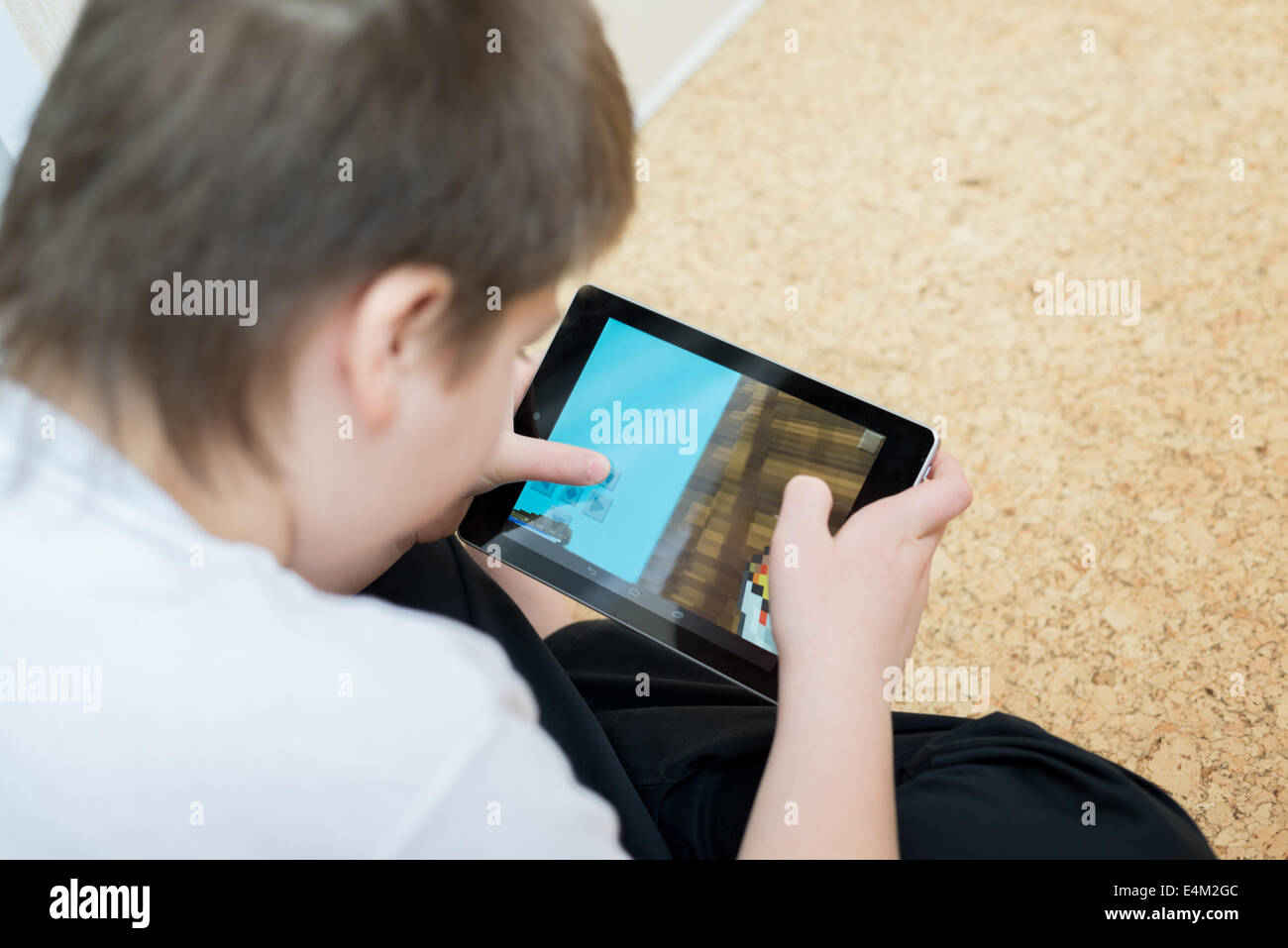 Boy playing on a Tablet PC Stock Photo - Alamy